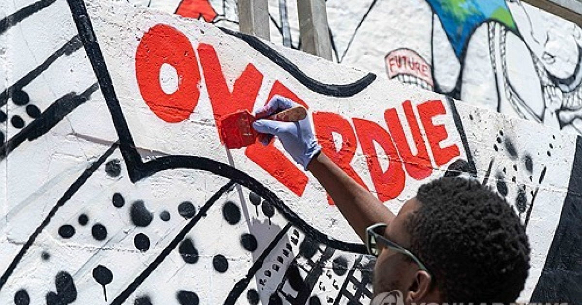 At G20 Summit in Johannesburg, Massive Mural Demands Debt Justice